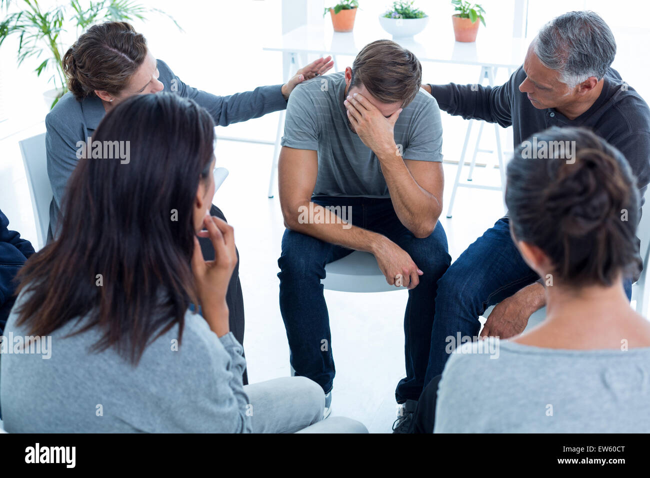 Concerned patients comforting another in hi-res stock photography and ...