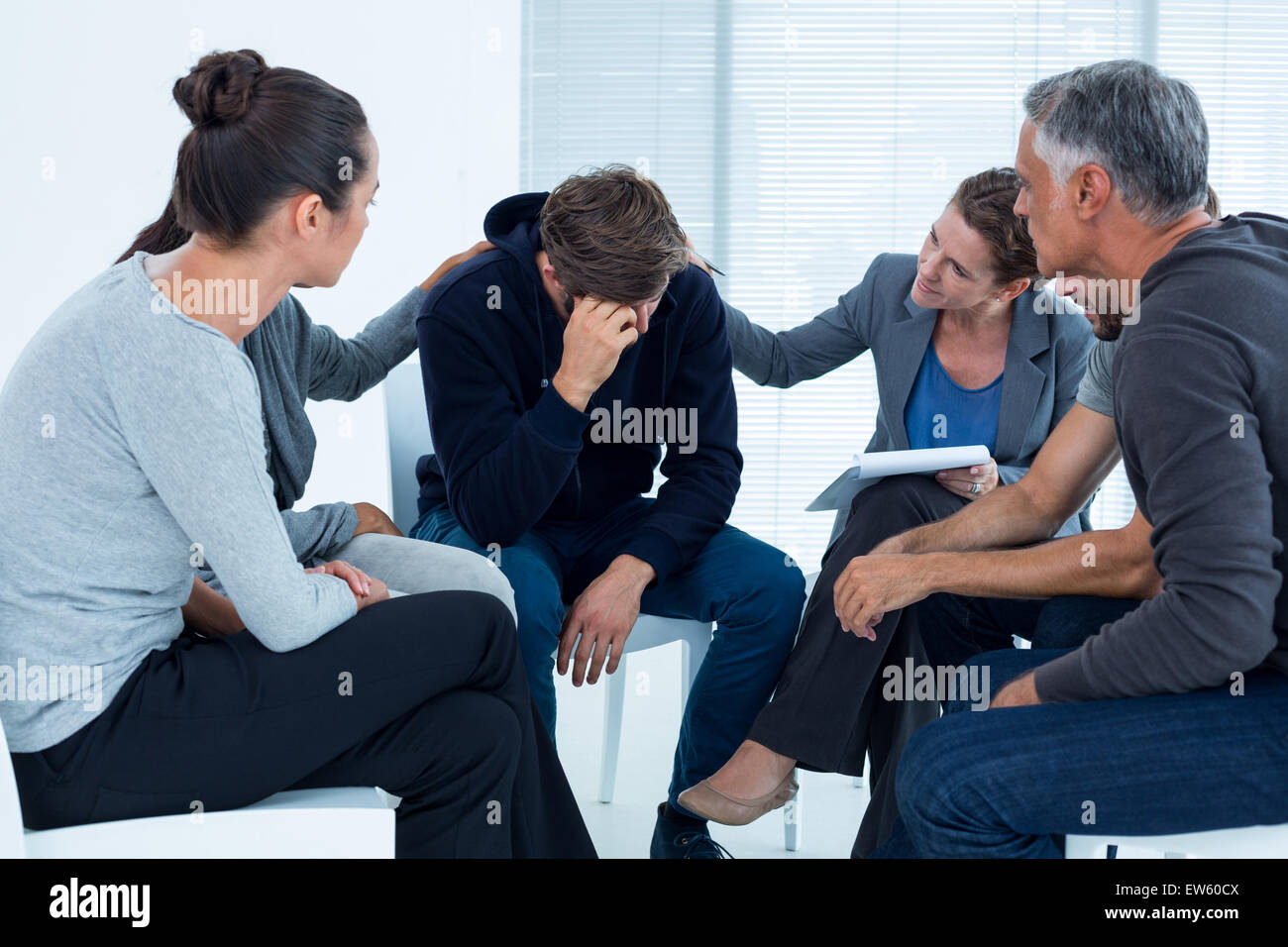 Concerned patients comforting another in hi-res stock photography and ...