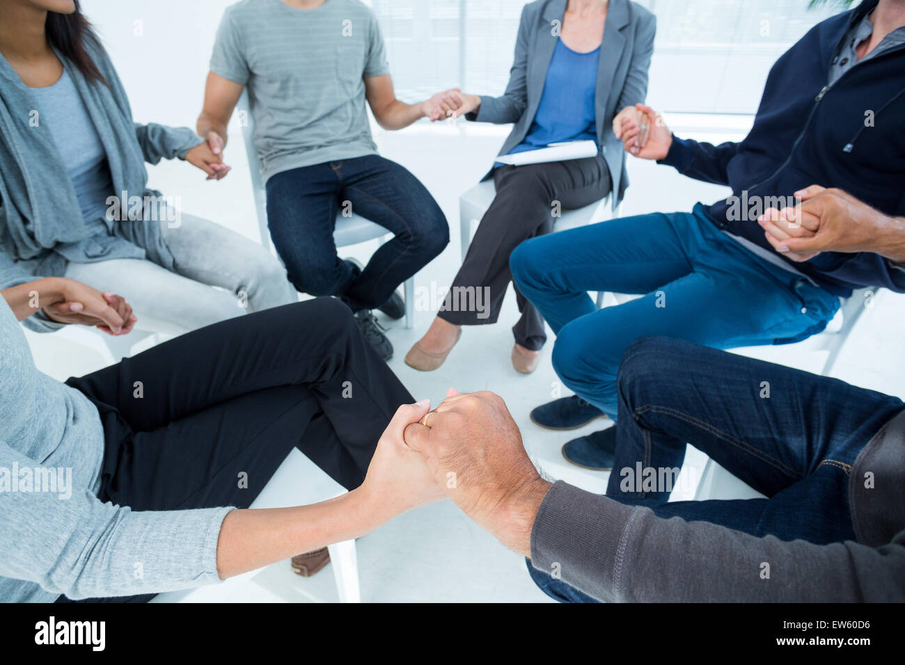 Group therapy in session sitting in a circle Stock Photo - Alamy