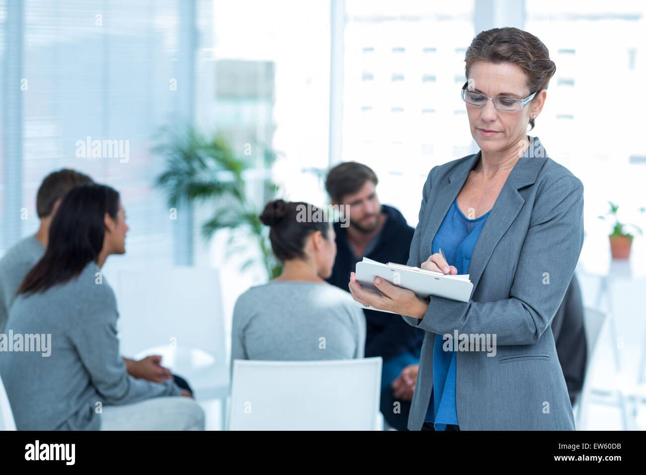 Therapist with group therapy in session Stock Photo - Alamy