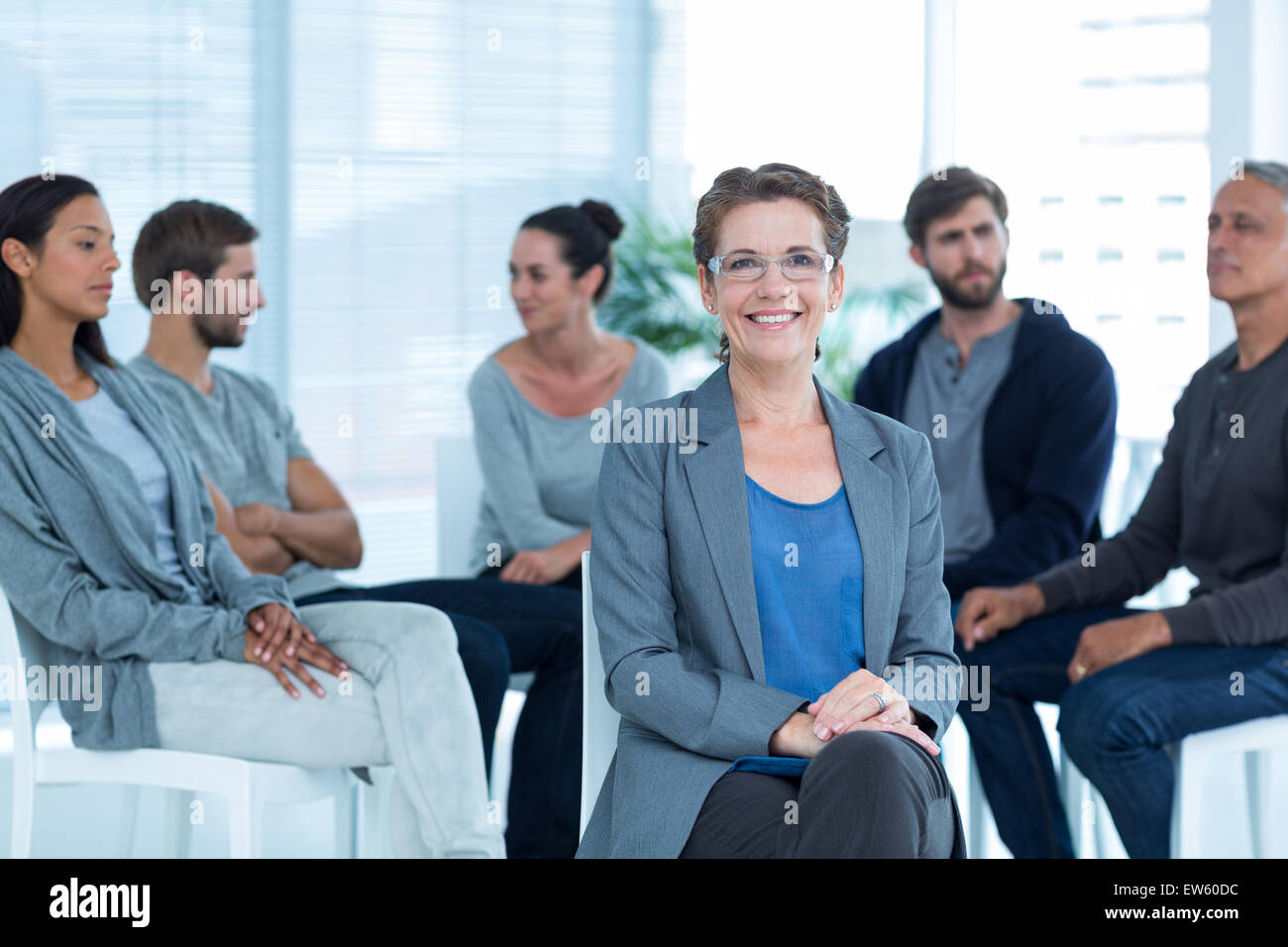 Therapist with group therapy in session Stock Photo - Alamy