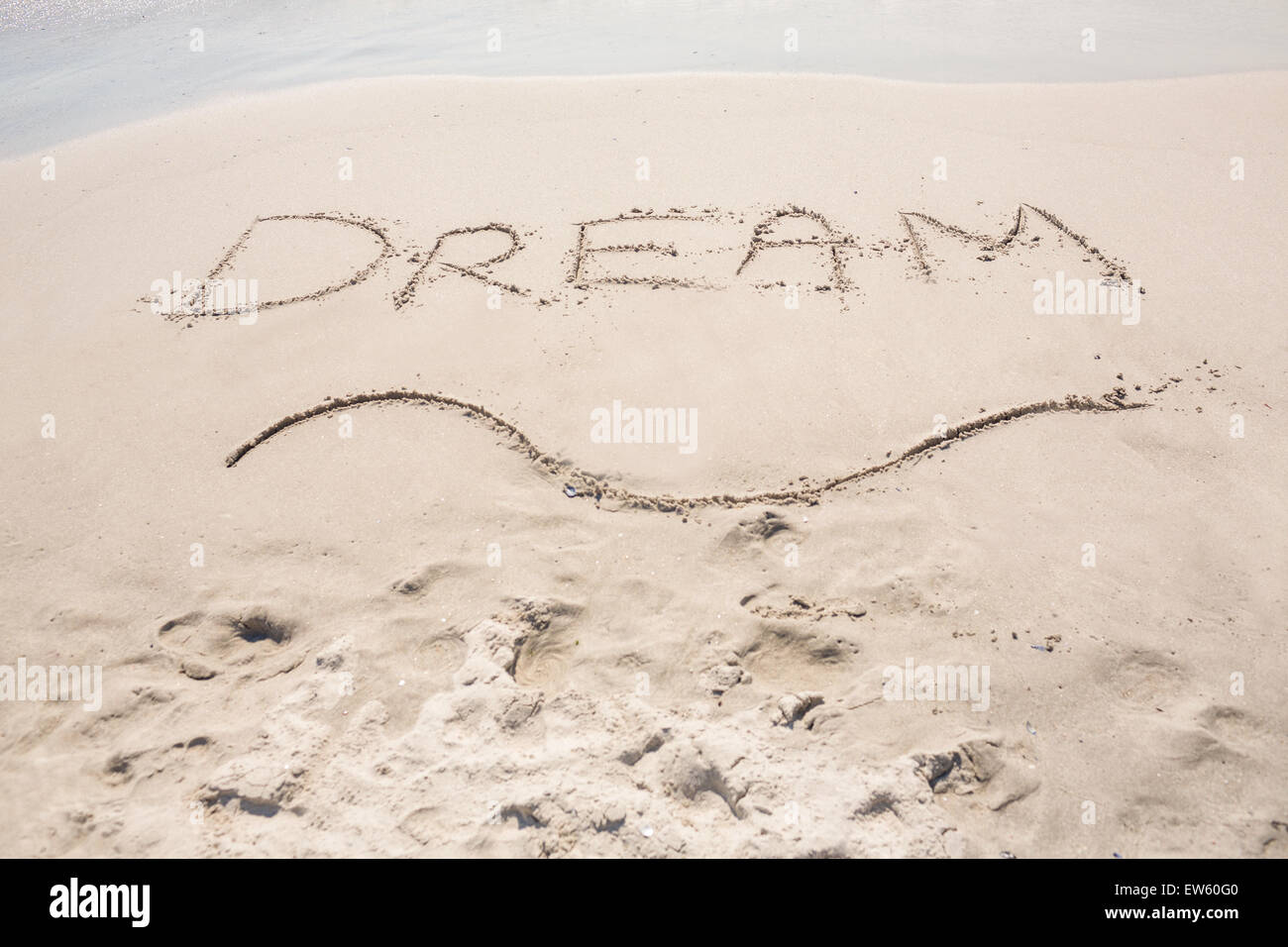 Inscription dream on sand Stock Photo - Alamy