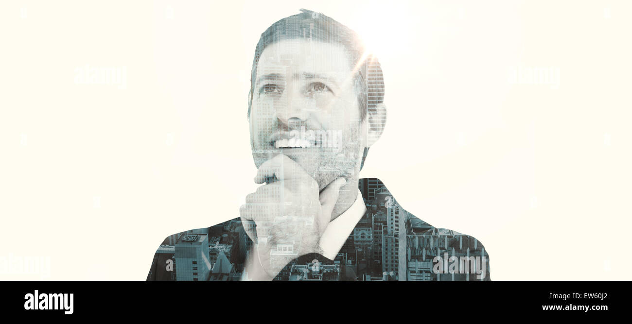 Composite image of businessman smiling and thinking Stock Photo - Alamy