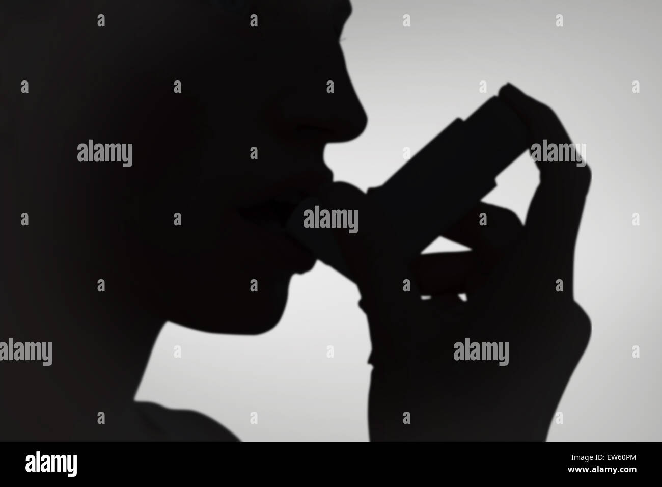 Composite image of blonde woman taking her inhaler Stock Photo - Alamy