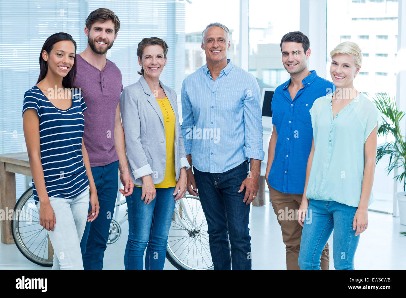 Smiling business team looking at the camera Stock Photo - Alamy
