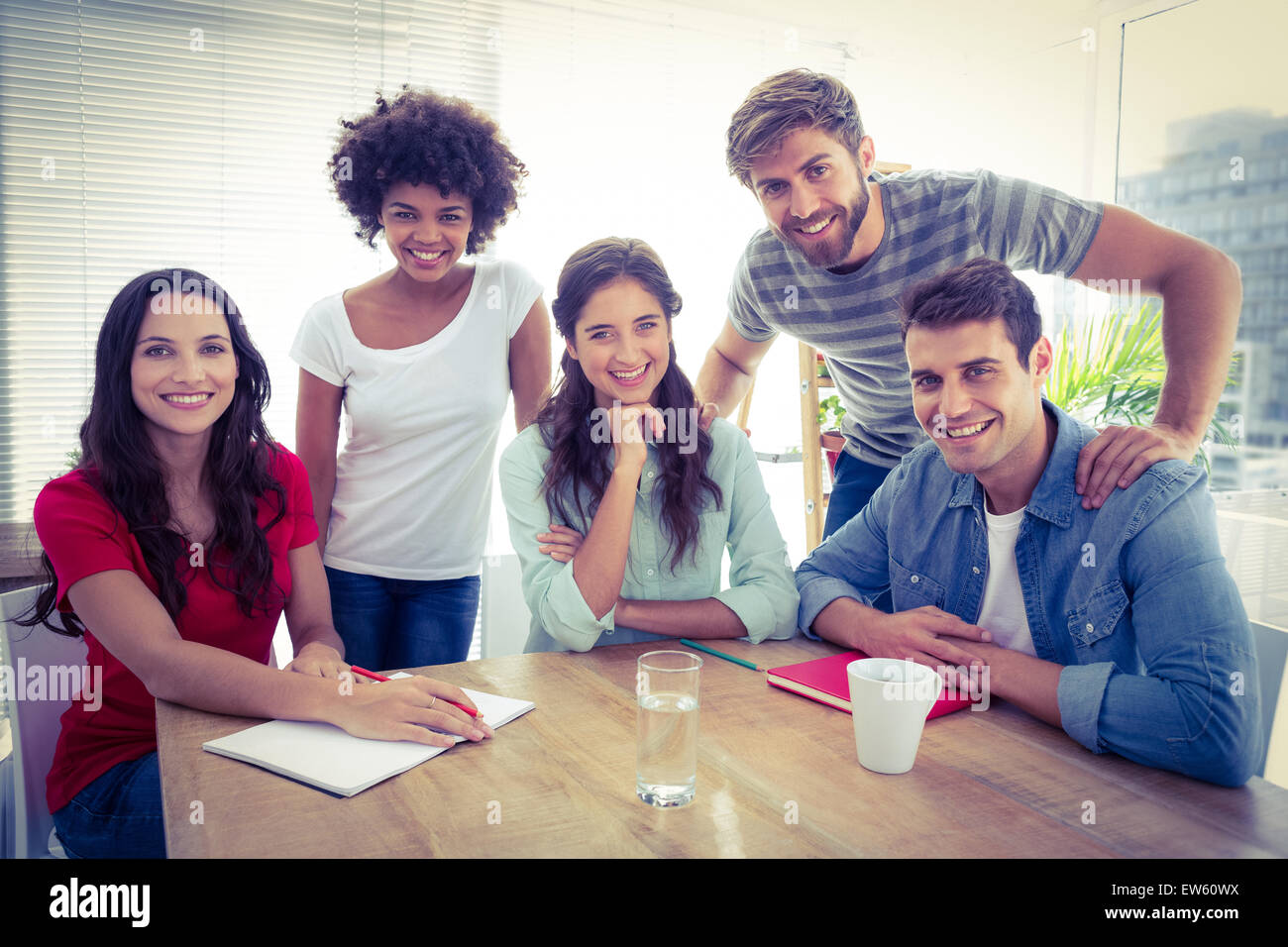 Portrait of a smiling business team looking at the camera Stock Photo ...