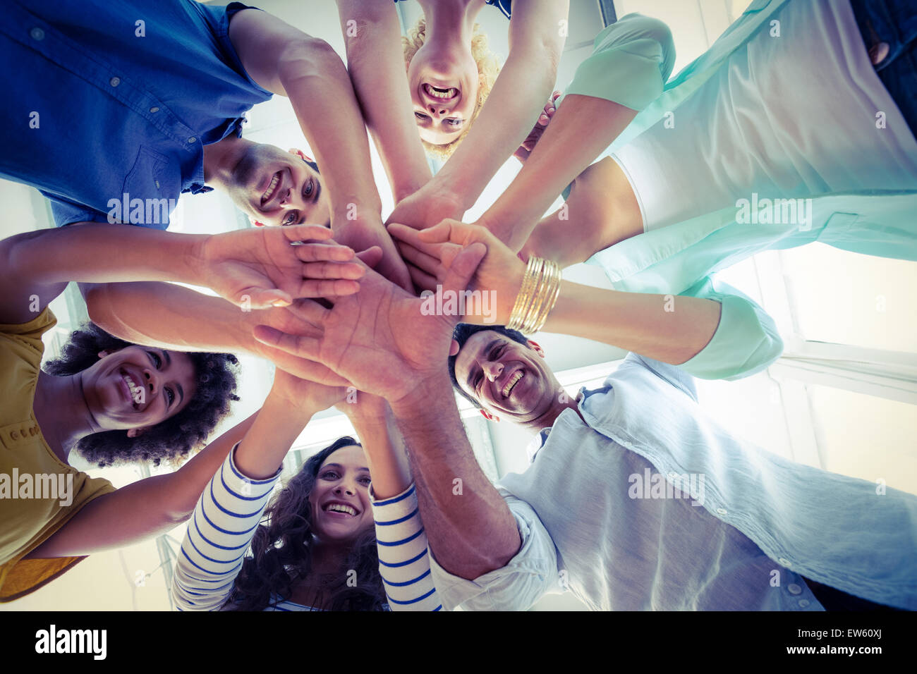 Creative team putting their hands together Stock Photo - Alamy