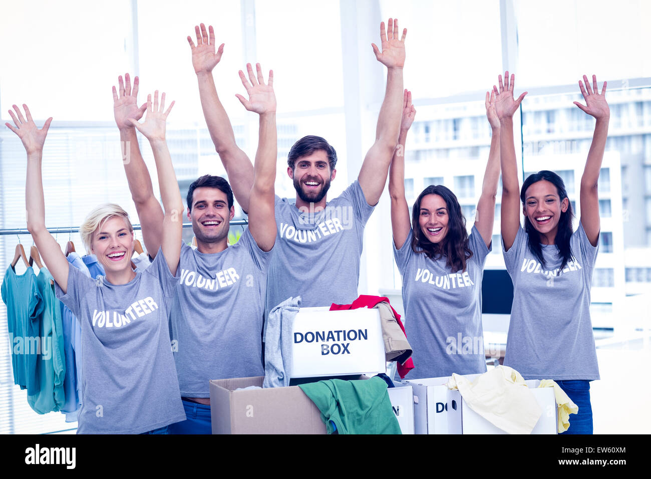 Volunteers raising their hands Stock Photo - Alamy