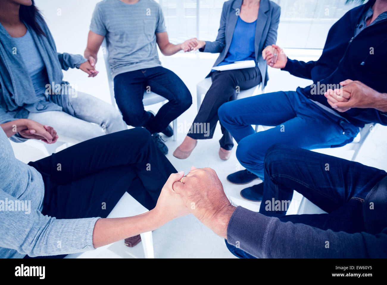 Group therapy in session sitting in a circle Stock Photo - Alamy