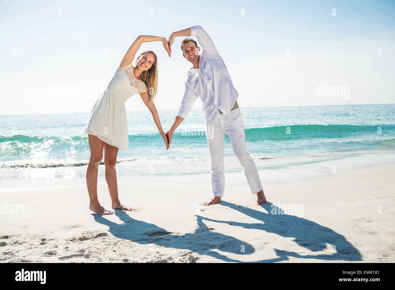 Happy couple forming heart shape with their hands Stock Photo - Alamy