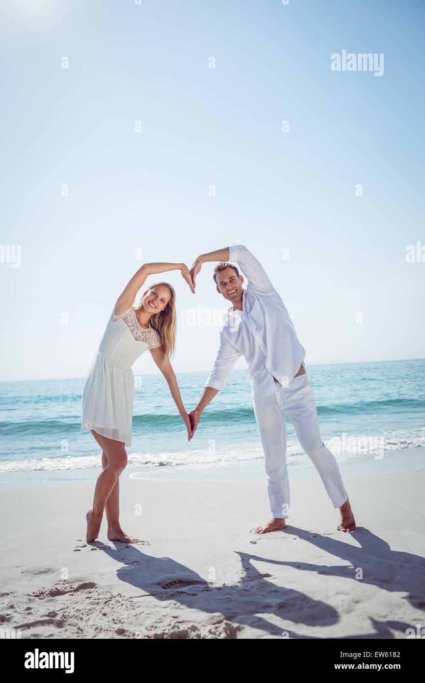 Happy couple forming heart shape with their hands Stock Photo - Alamy