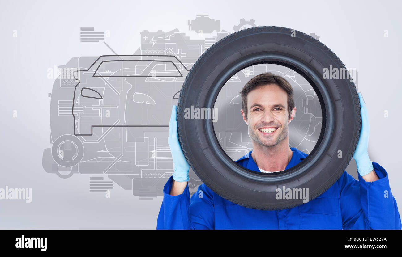 Composite image of confident mechanic looking through tire Stock Photo ...