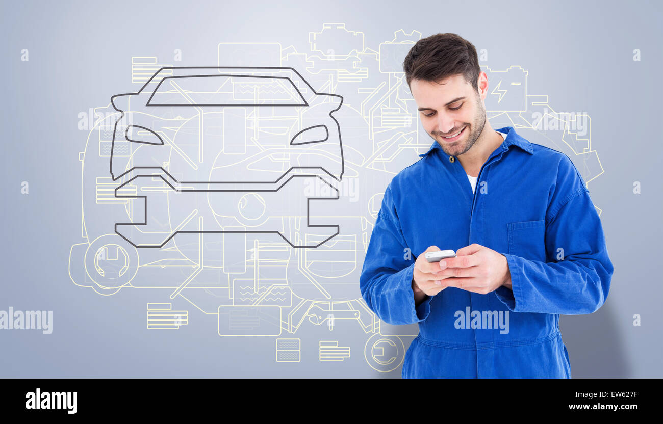 Composite image of male mechanic text messaging through mobile phone ...