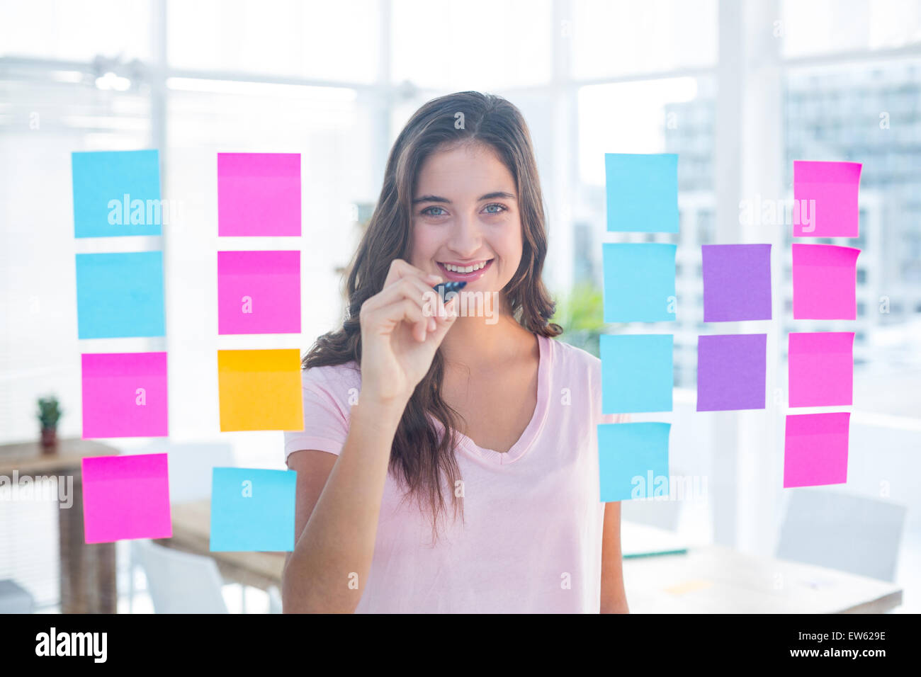 Smiling women writing photo editor Stock Photo - Alamy