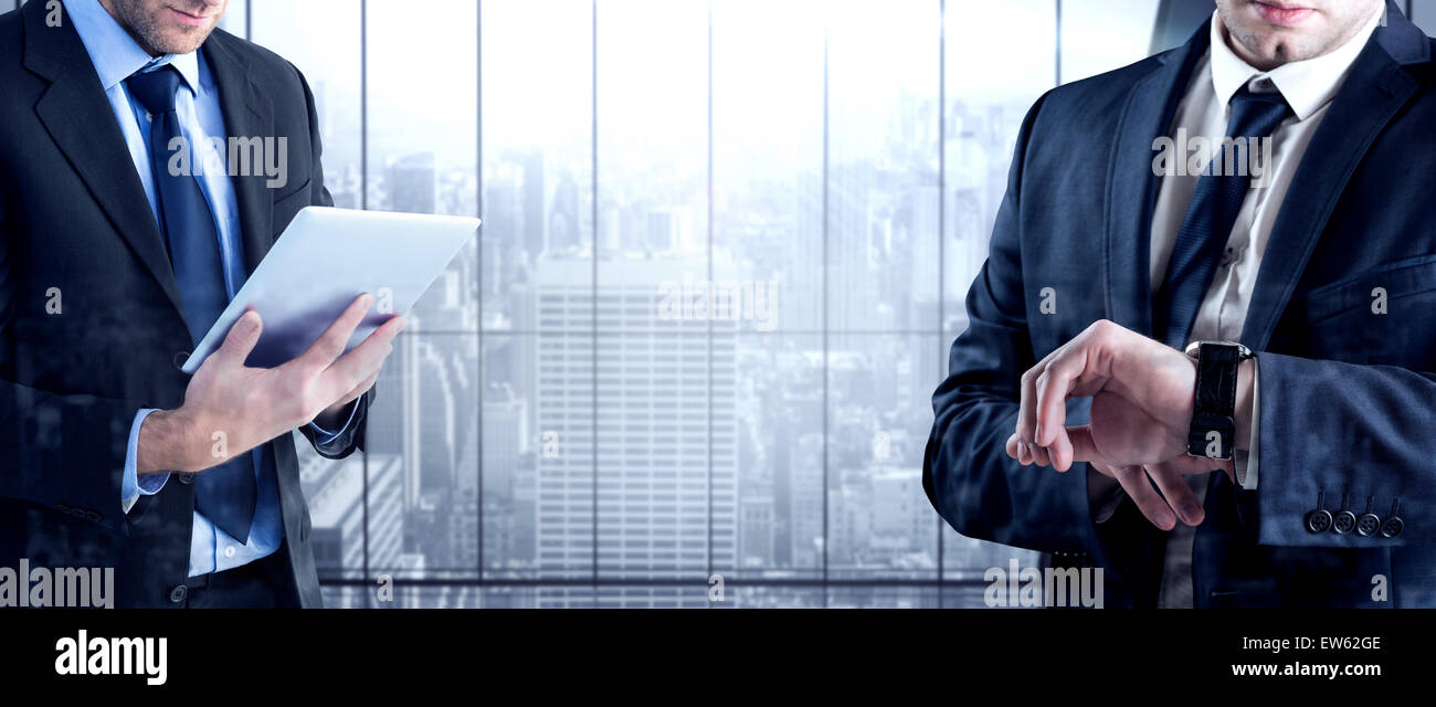 Composite image of businessman checking the time on watch Stock Photo ...