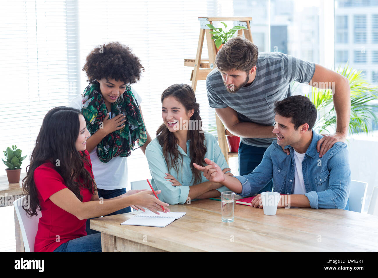 Young colleagues in discussion at office Stock Photo - Alamy