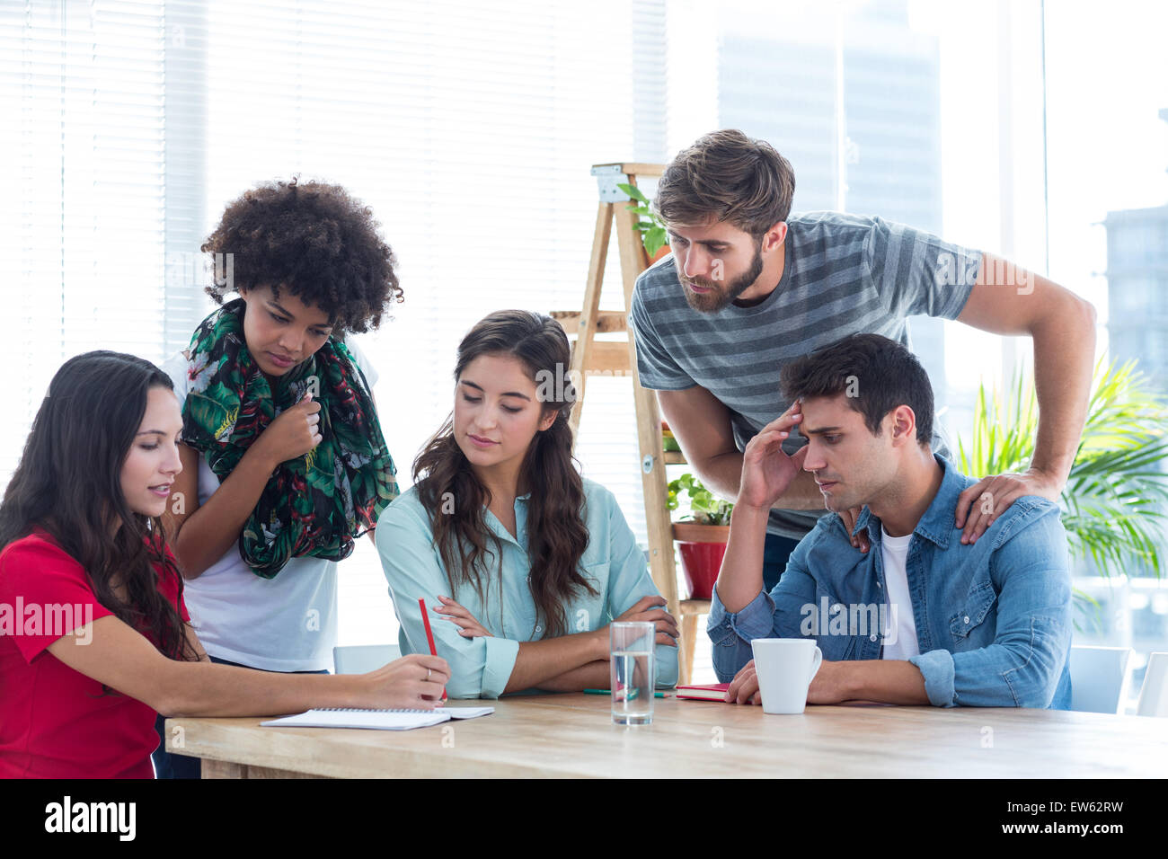 Young colleagues in discussion at office Stock Photo - Alamy