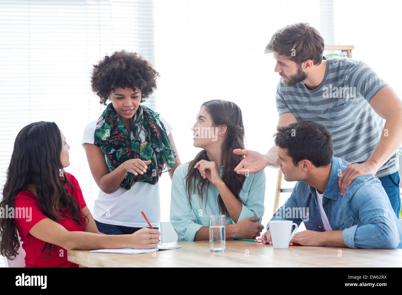 Young colleagues in discussion at office Stock Photo - Alamy