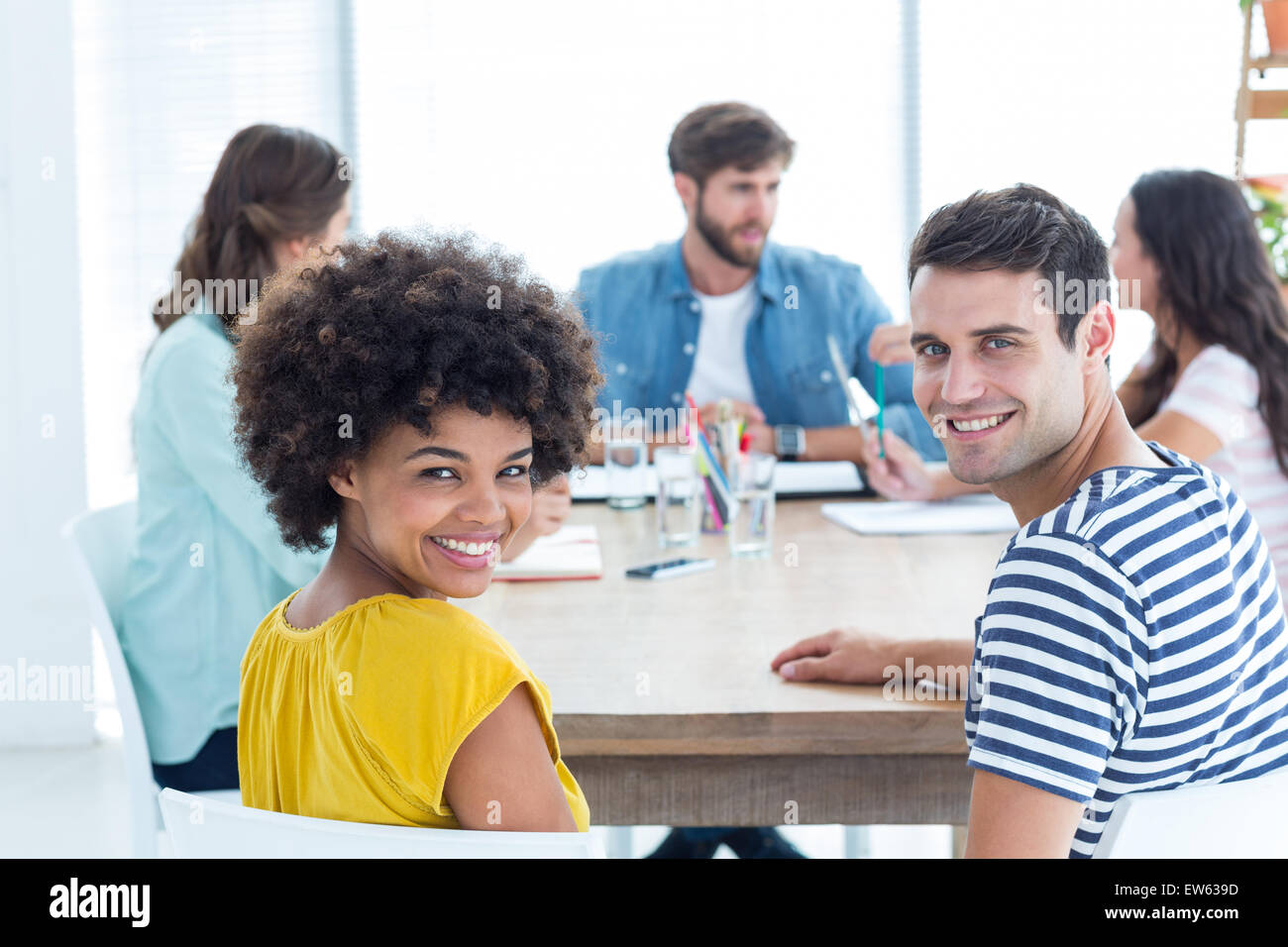 Smiling students at the table Stock Photo - Alamy