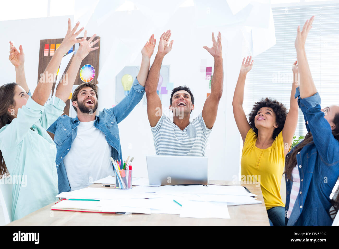 Group of young colleagues using laptop Stock Photo - Alamy