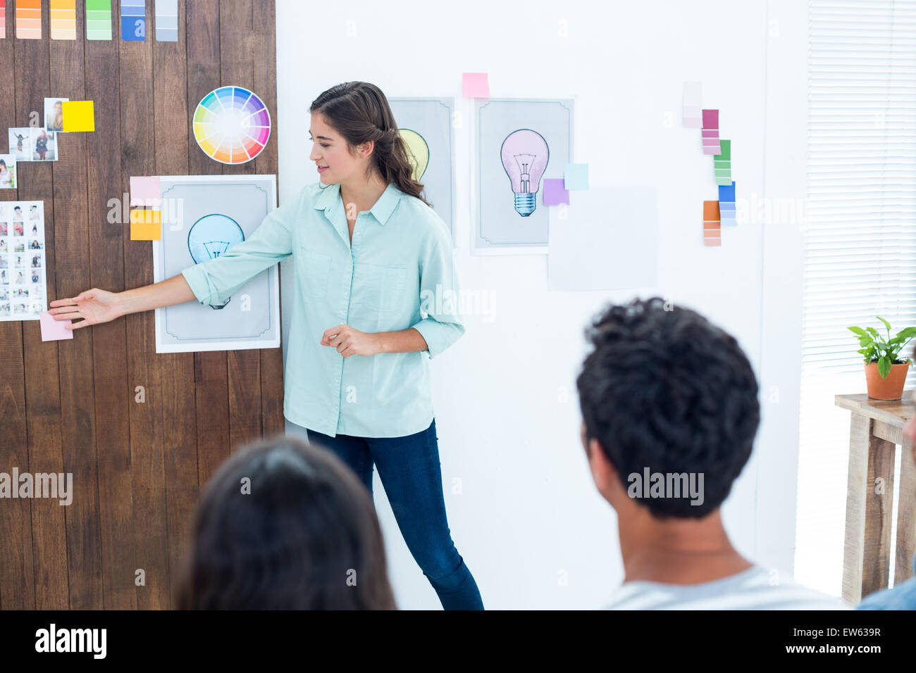 Casual young businessman giving presentation to colleagues Stock Photo ...
