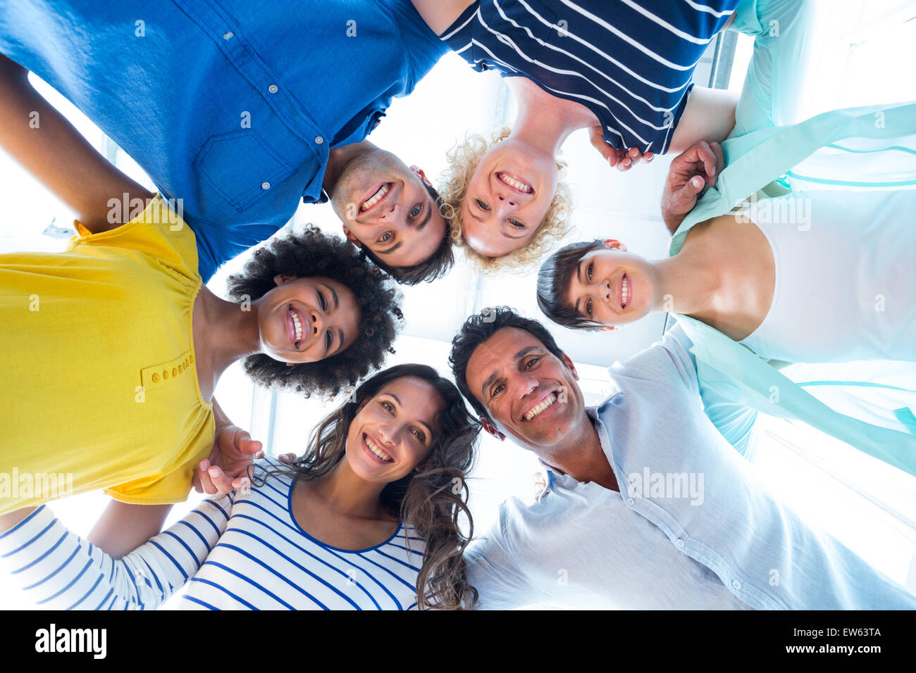 Creative team forming huddle Stock Photo - Alamy