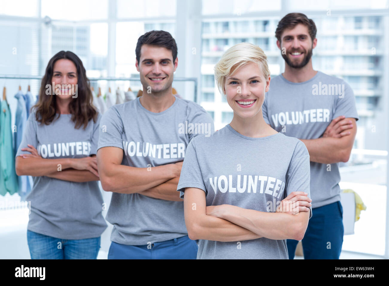 Smiling volunteers crossed arms hi-res stock photography and images - Alamy