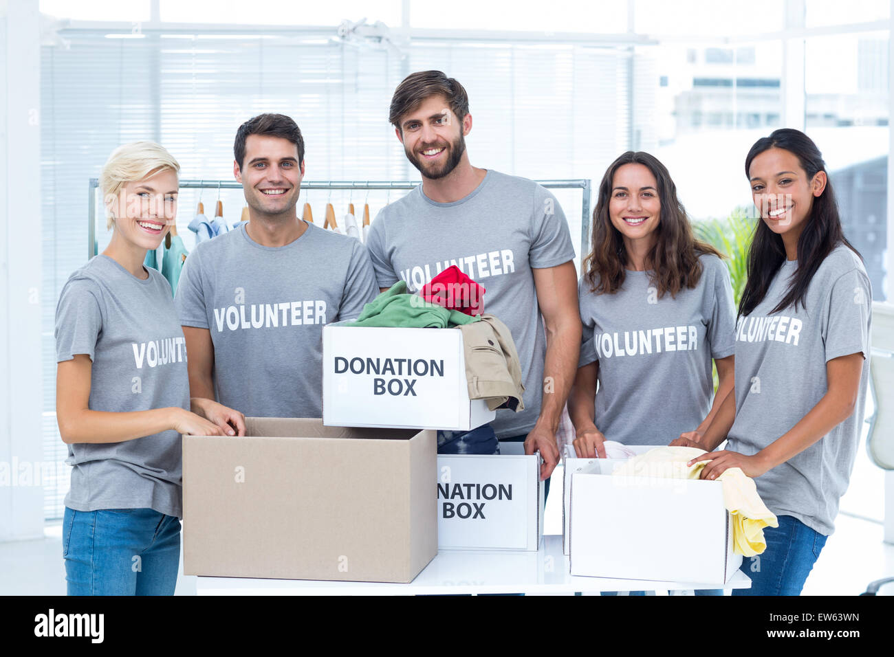 Volunteers separating donation stuffs Stock Photo - Alamy