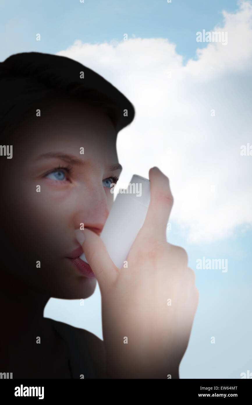 Composite image of blonde woman taking her inhaler Stock Photo - Alamy