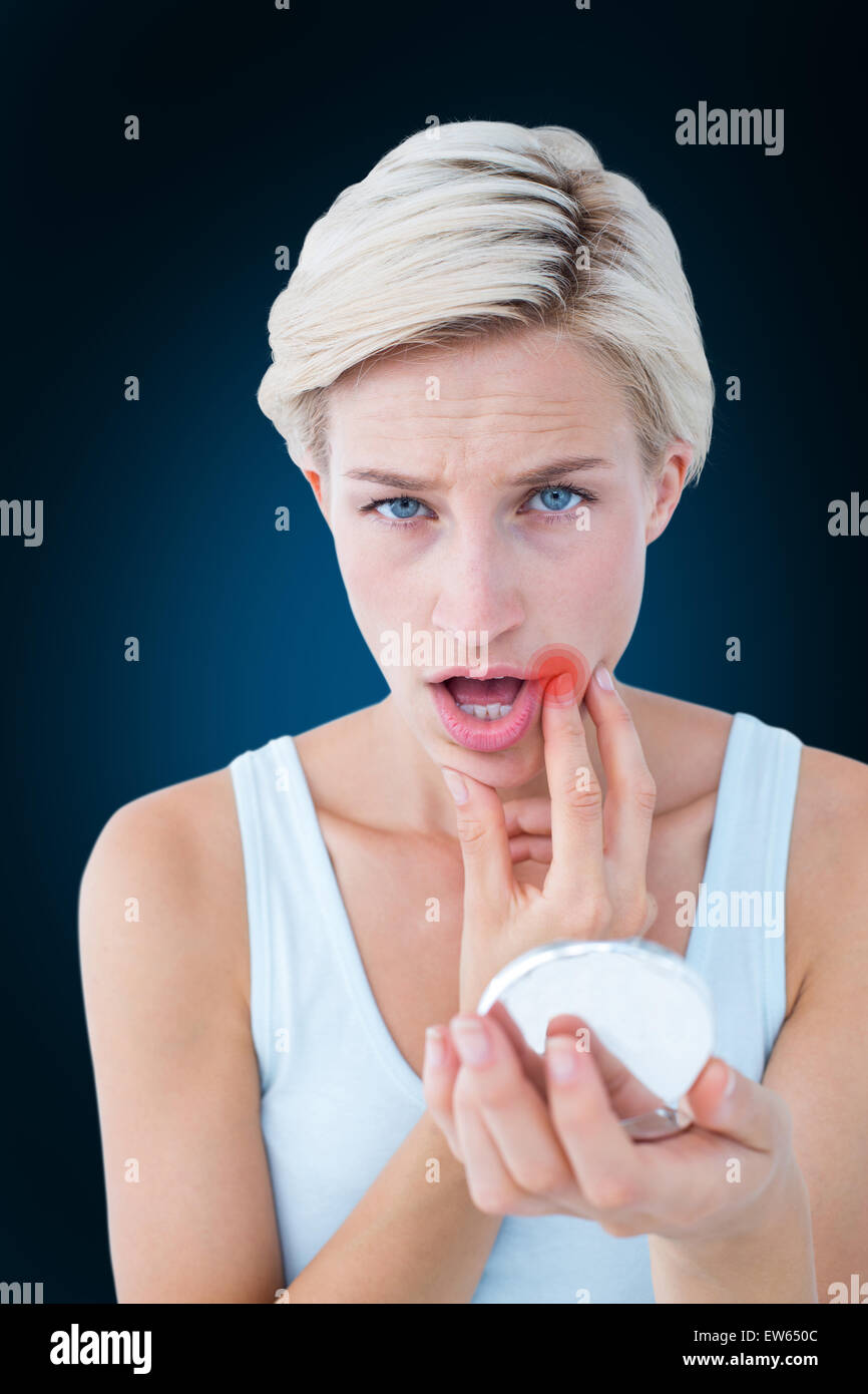 Composite image of shocking woman with mirror looking at camera Stock ...