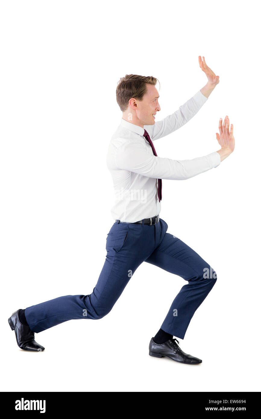 A businessman pushing something Stock Photo - Alamy