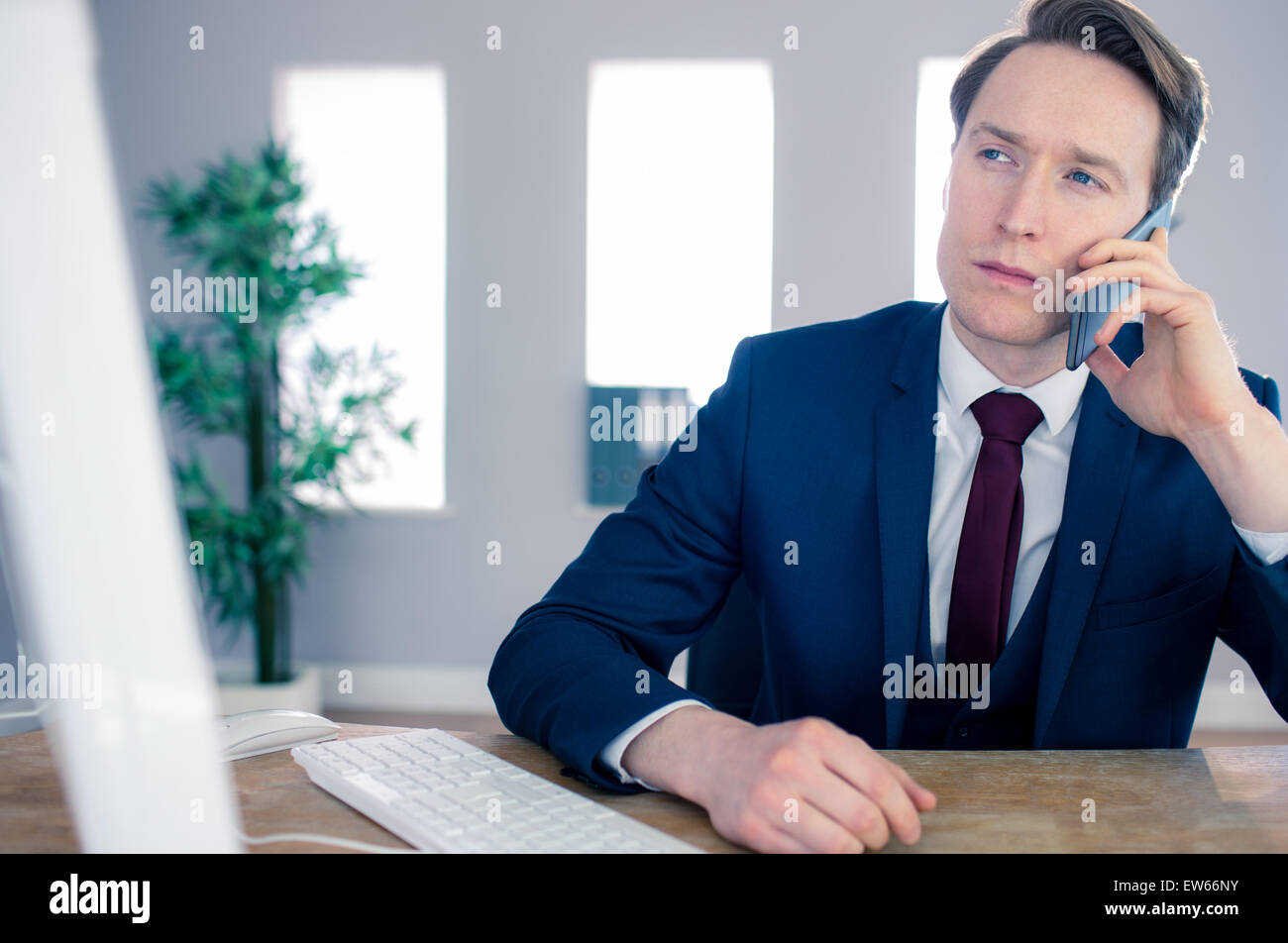 Serious businessman having a phone call Stock Photo - Alamy