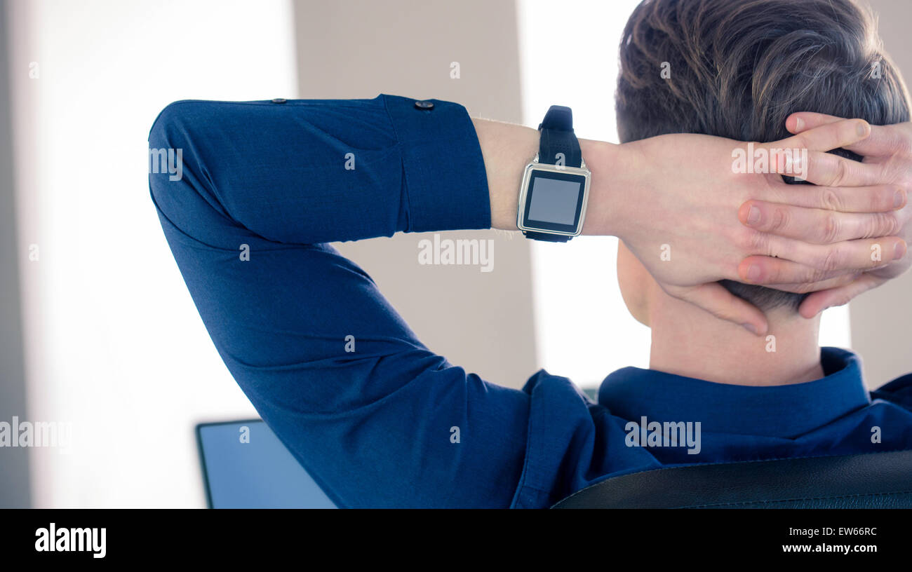 Rear view of businessman wearing smartwatch Stock Photo - Alamy