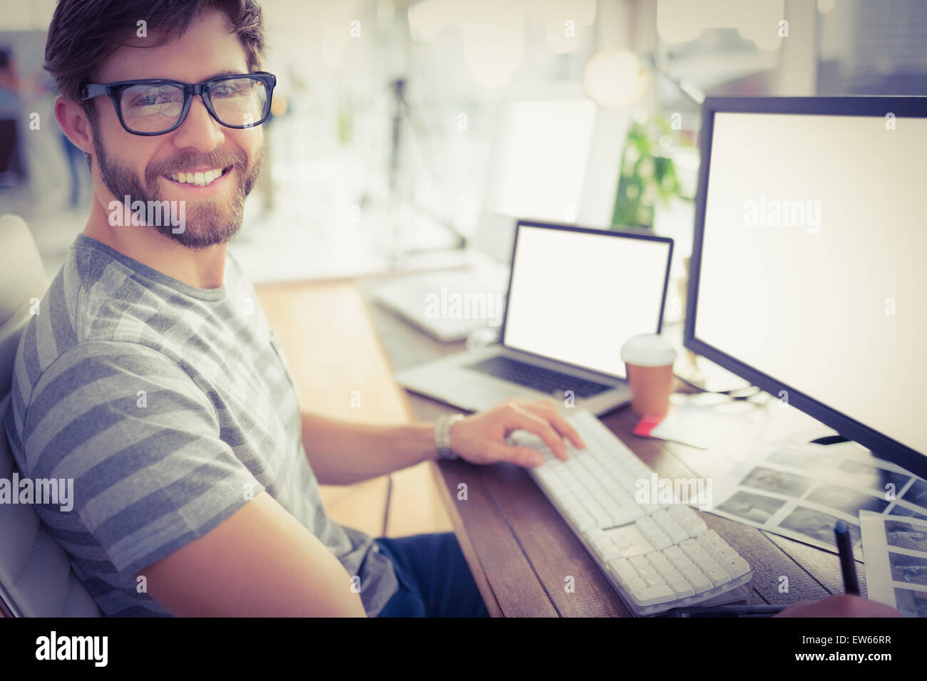 Casual businessman using computer in office Stock Photo - Alamy
