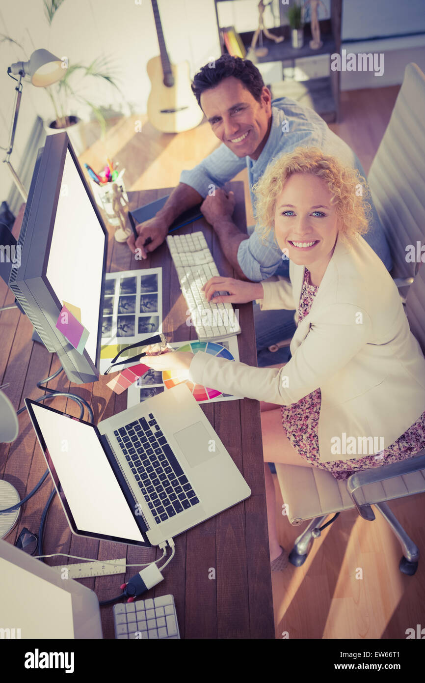 Happy business colleagues smiling at the camera Stock Photo - Alamy