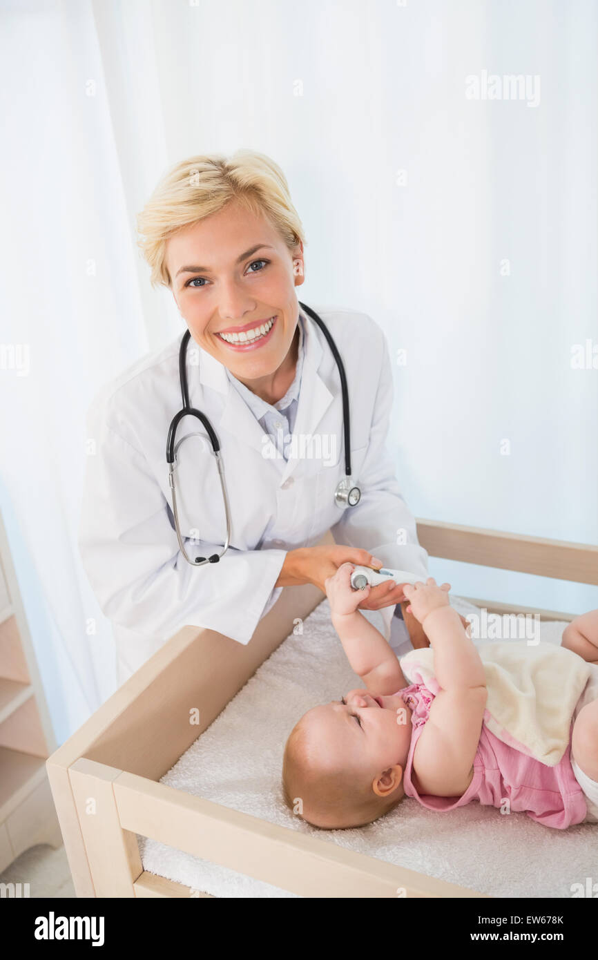 Portrait blonde doctor and baby girl taking a temperature Stock Photo ...