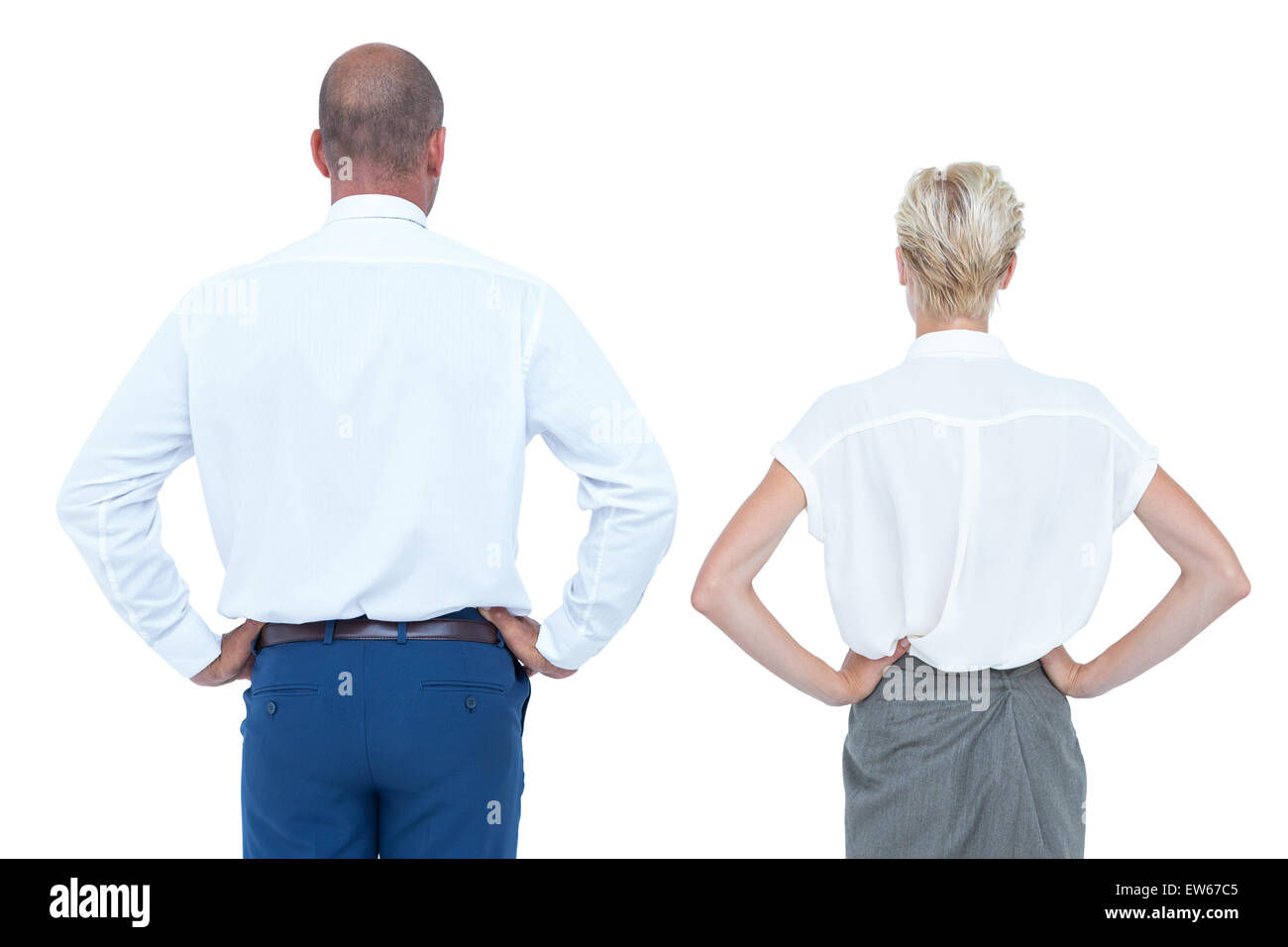 Smiling business people with hands on the hips Stock Photo - Alamy