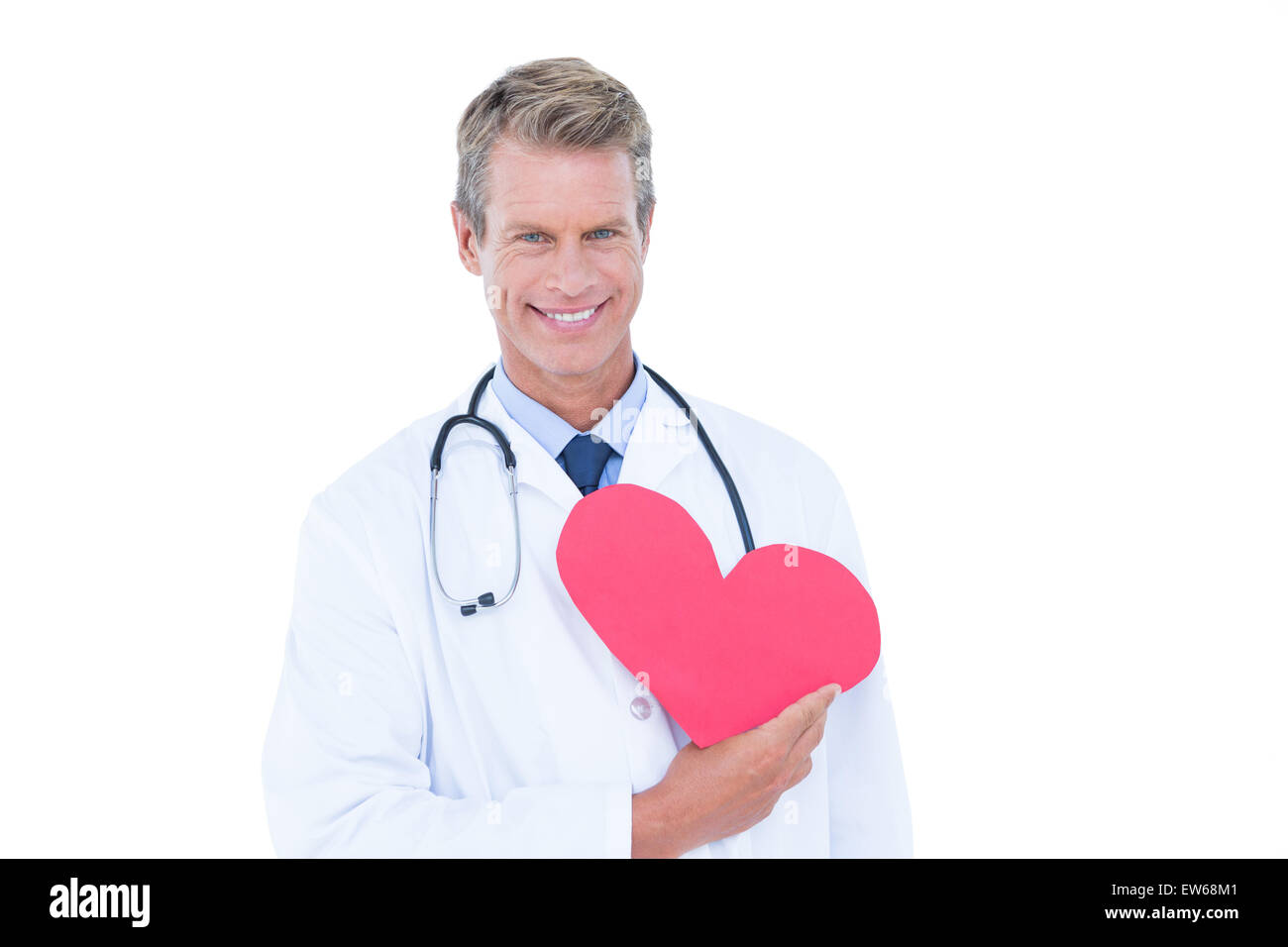 Smiling doctor holding heart card Stock Photo - Alamy
