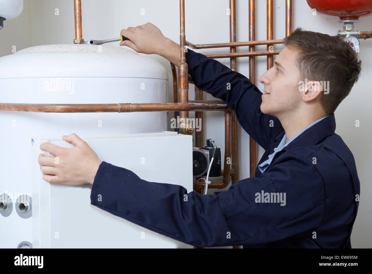 Male Plumber Working On Central Heating Boiler Stock Photo - Alamy