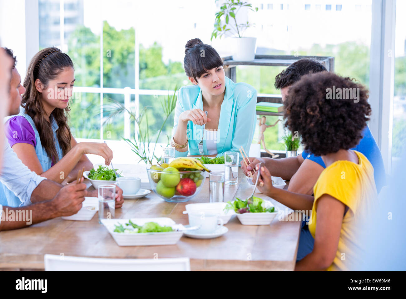 Group of friend eating together Stock Photo - Alamy