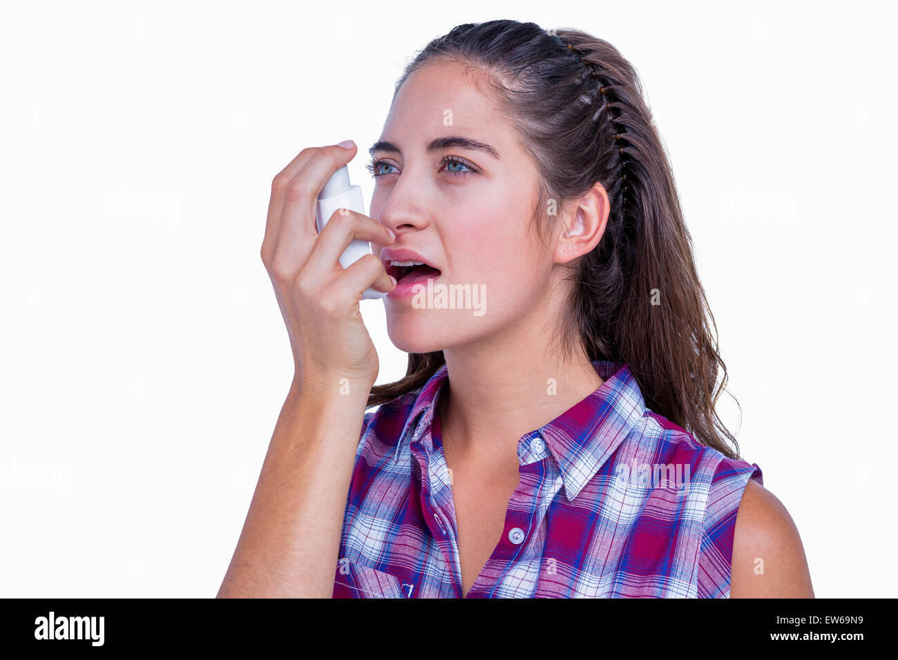 Pretty brunette woman using asthma inhaler Stock Photo - Alamy