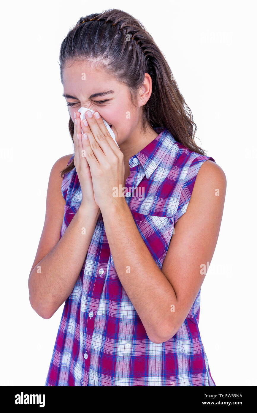 Pretty brunette woman blowing her nose Stock Photo - Alamy