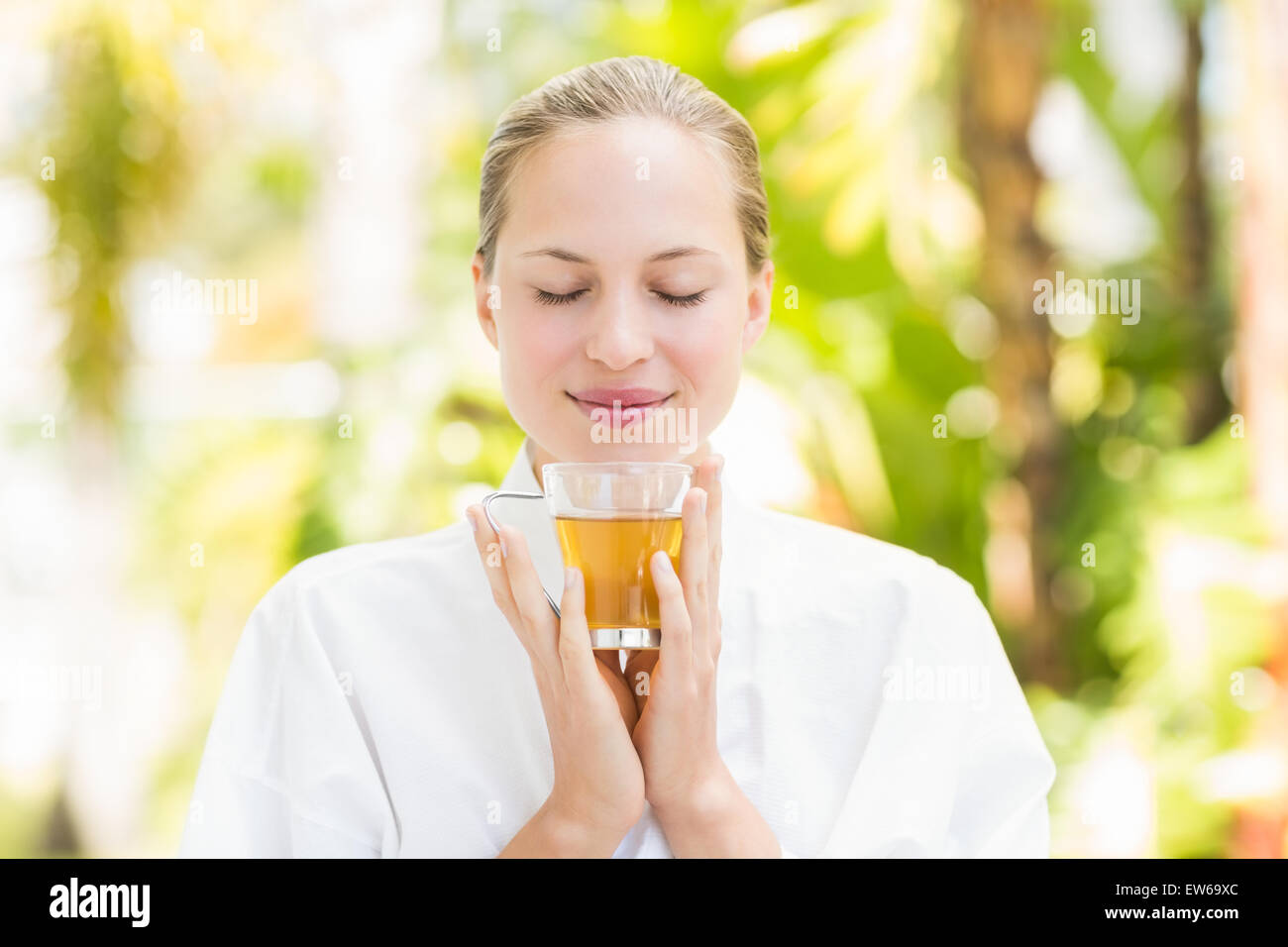 Attractive woman drinking tea Stock Photo - Alamy
