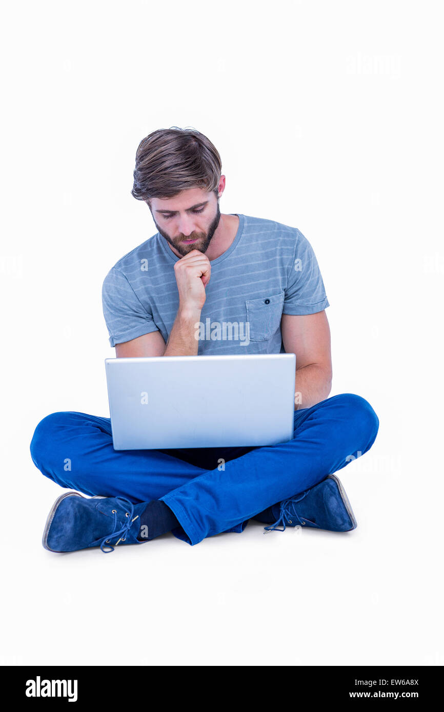 Handsome man thinking behind his laptop Stock Photo - Alamy