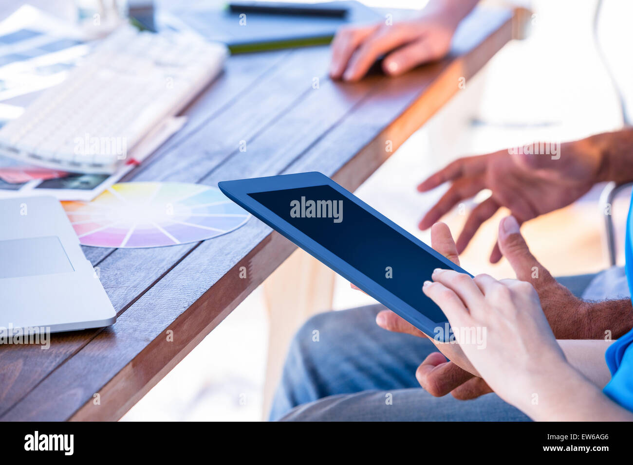 Close up of creative business people using tablet Stock Photo - Alamy