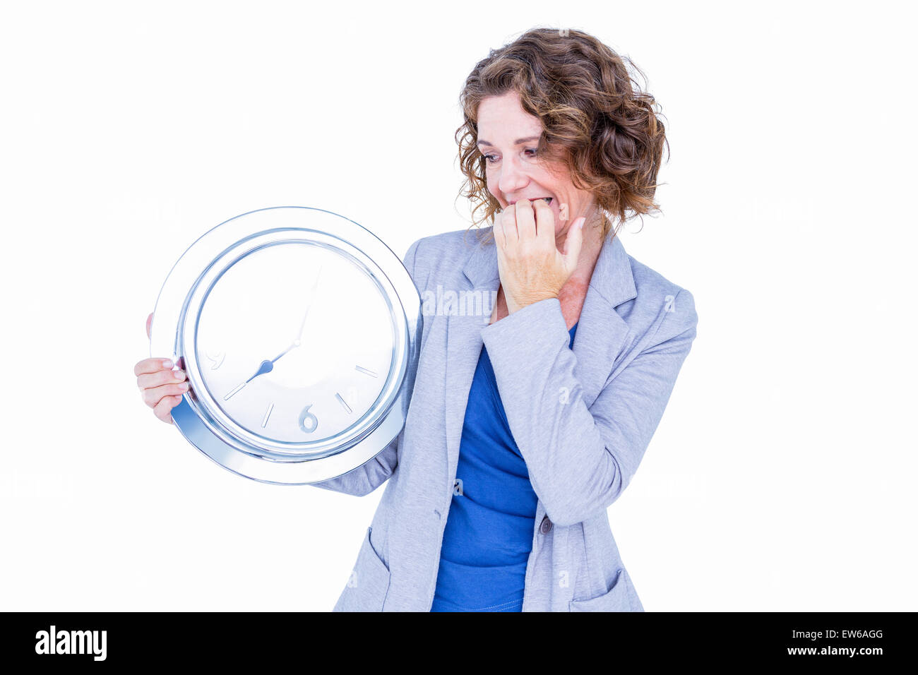 An anxious businesswoman holding clock Stock Photo - Alamy