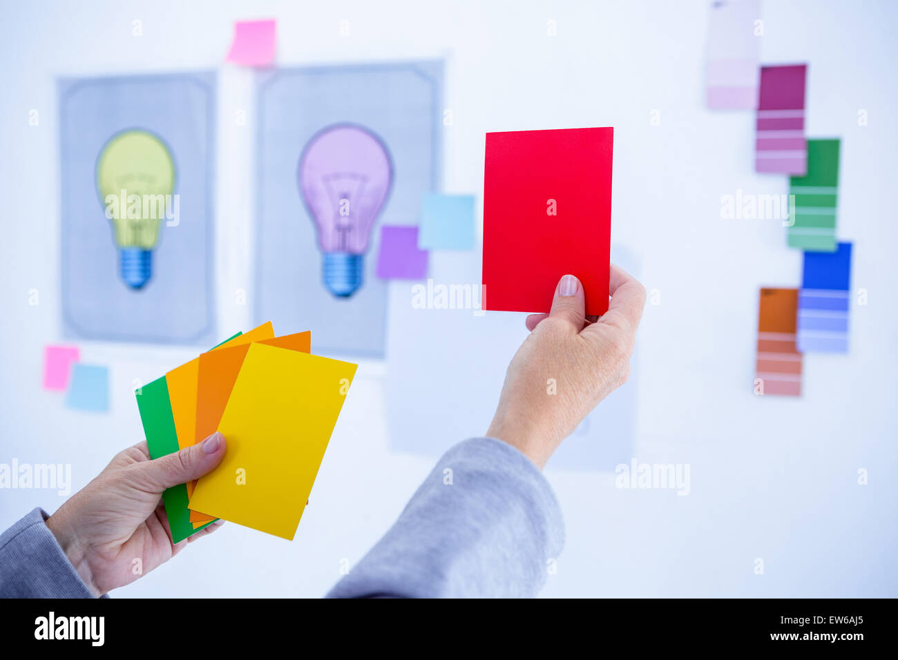 Creative businesswoman holding color cards Stock Photo - Alamy