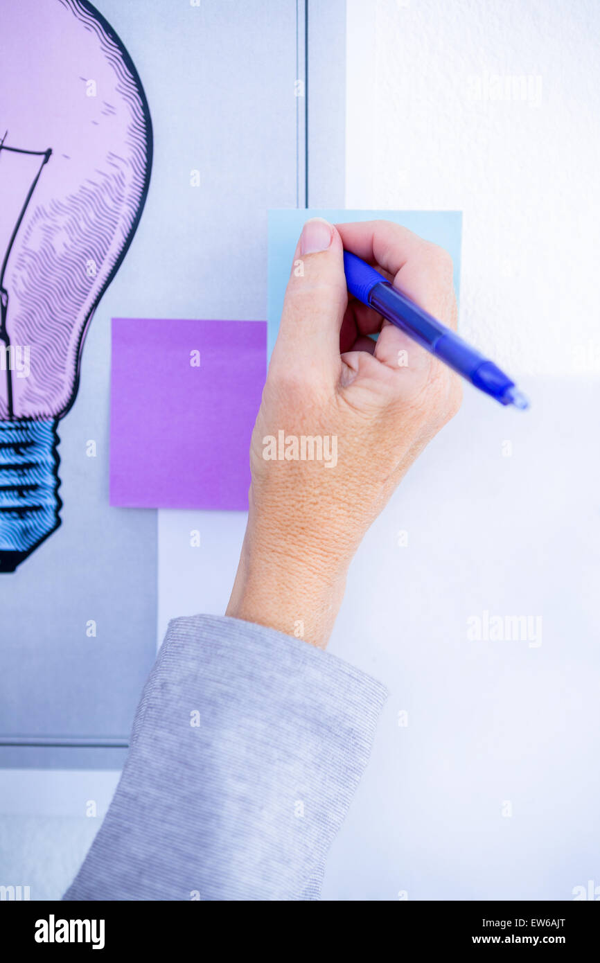Woman writing post it note hi-res stock photography and images - Alamy