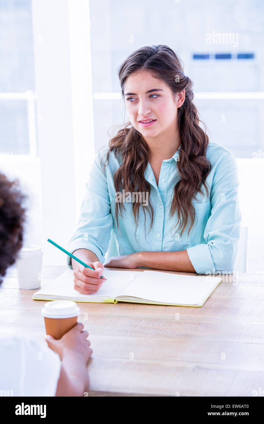 Concentrated woman taking notes during a meeting Stock Photo - Alamy