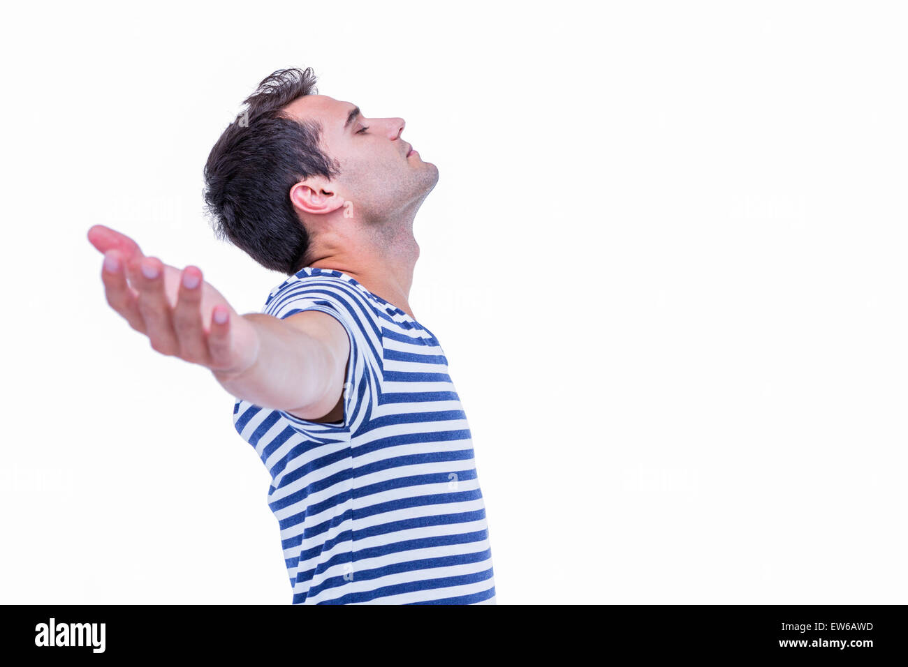 Side view of handsome hipster with arms outstretched Stock Photo - Alamy